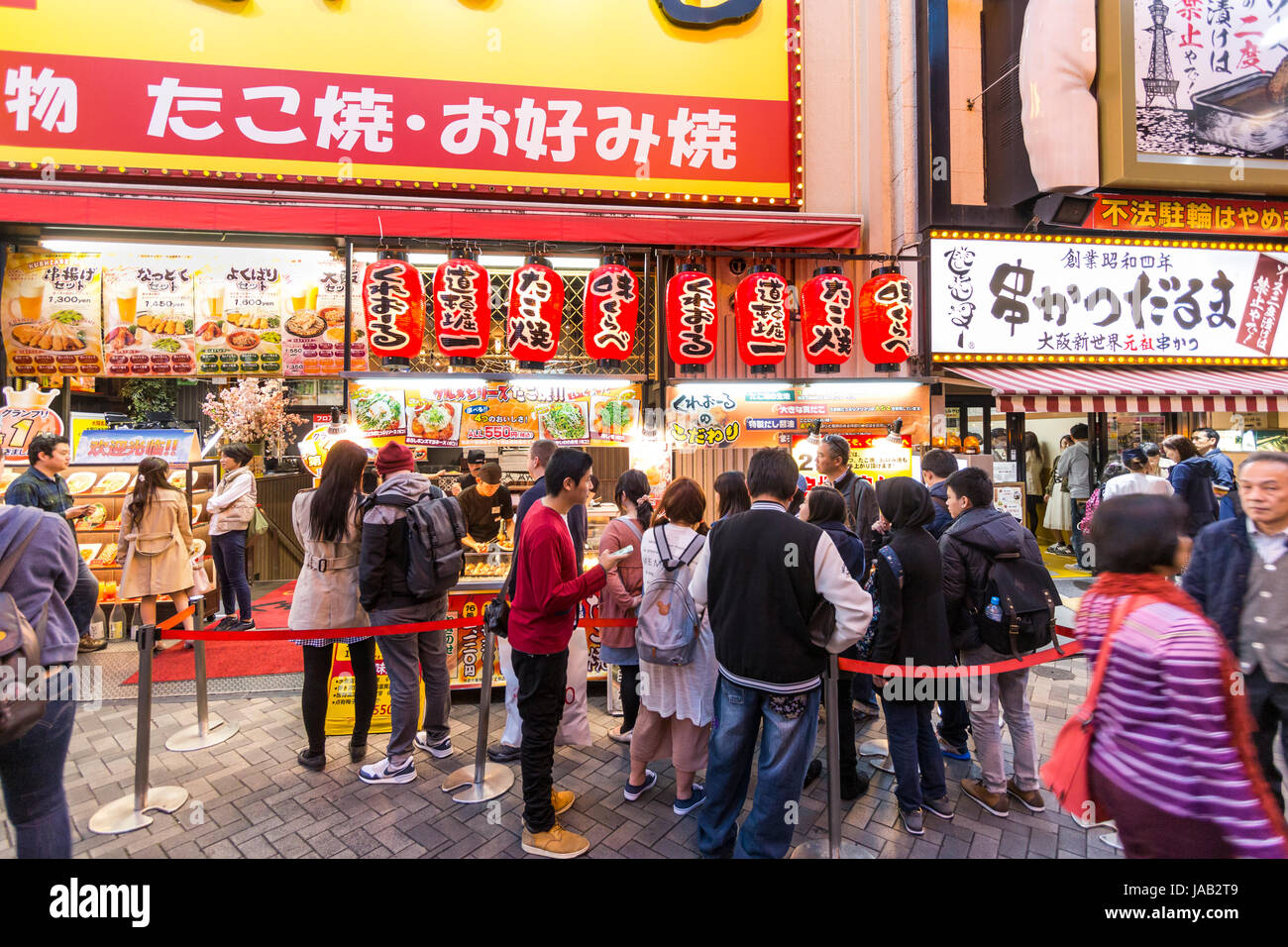 Dotonbori, Osaka. People queuing up to buy traditional Japanese food ...