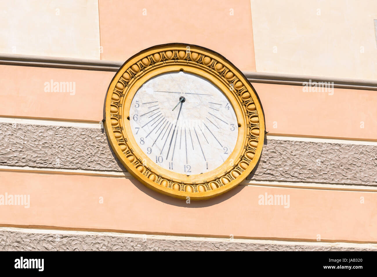 Round decorative vintage sundial on the wall Stock Photo - Alamy