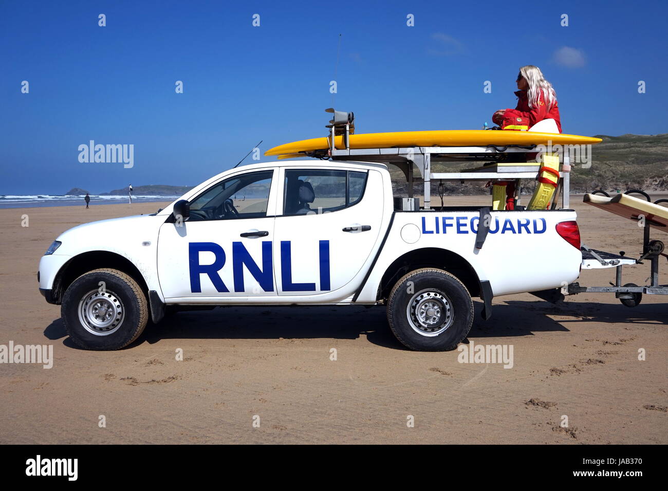 Newquay, Cornwall, UK - April 7 2017: Female RNLI lifeguard keeping ...