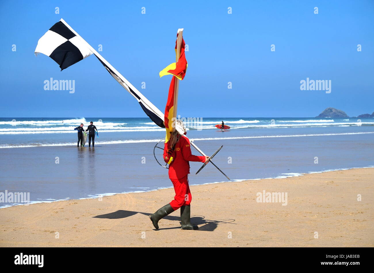 Newquay, Cornwall, UK - April 7 2017: Female RNLI lifeguard moving the ...