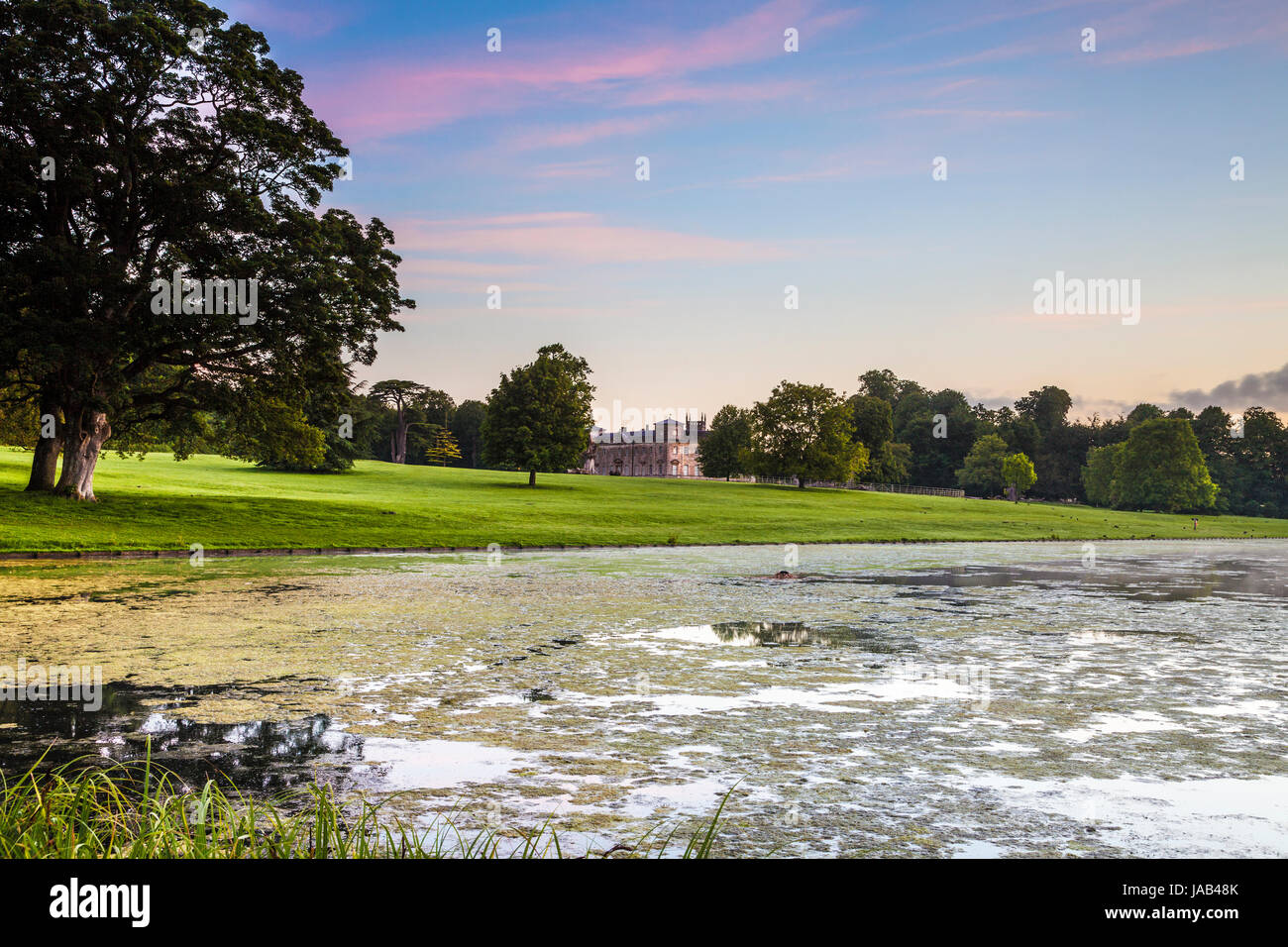 A summer sunrise view over the lake at Lydiard Park in Swindon ...