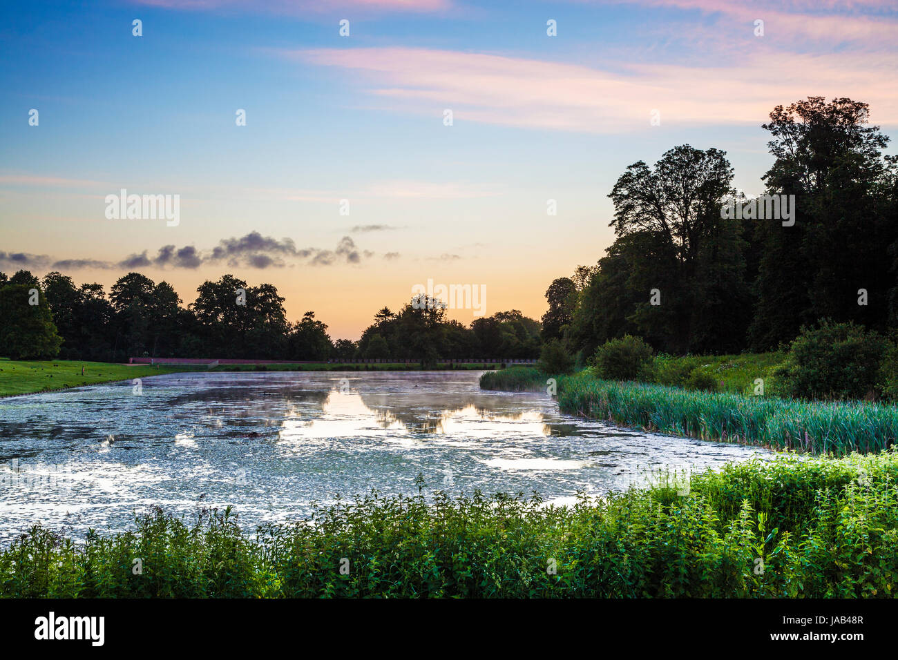 A summer sunrise over the lake at Lydiard Park in Swindon, Wiltshire ...