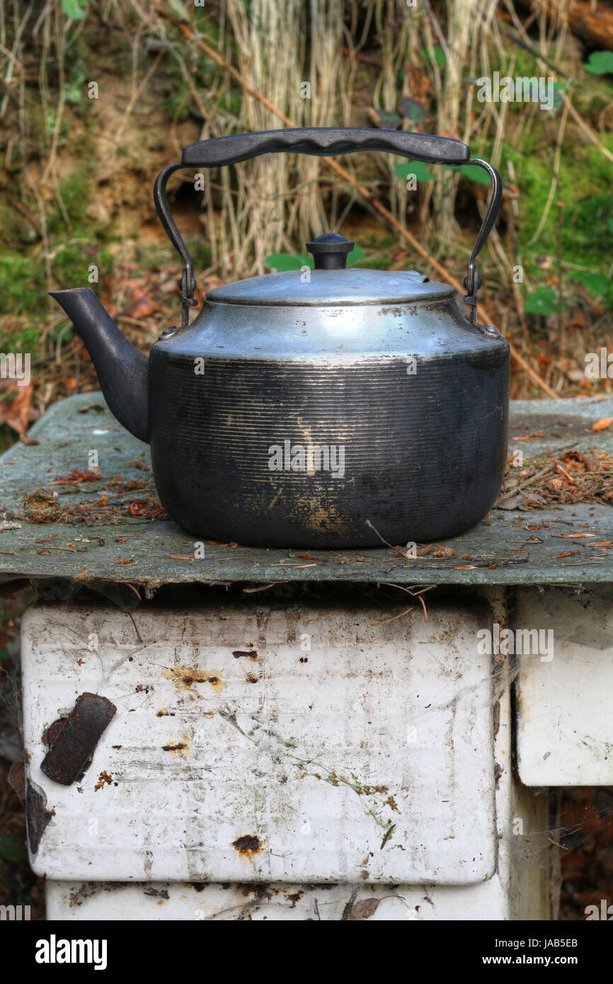 Detail of the old and worn teapot on old stove Stock Photo - Alamy