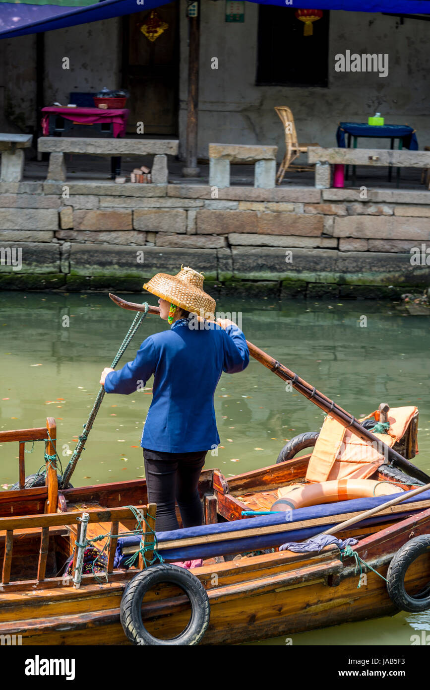 Person rowing a boat on a canal, Ancient water town of Tongli, Suzhou ...