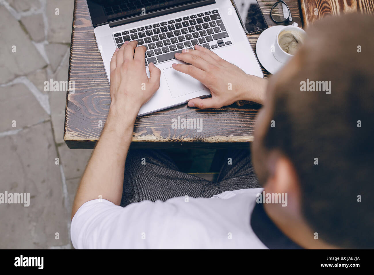 a young bank employee busy on a laptop during lunch break Stock Photo ...