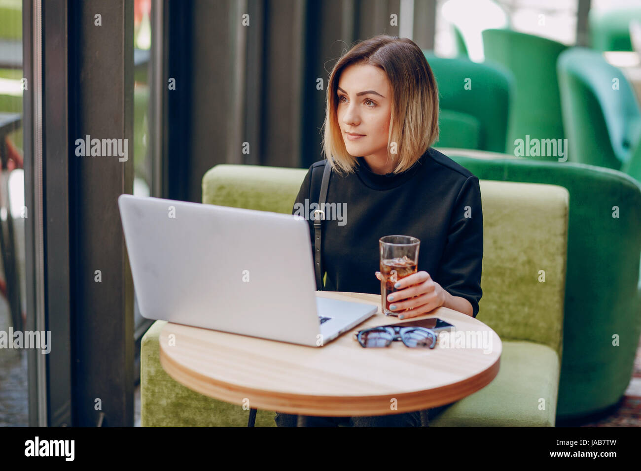 young beautiful girl using the laptop during a break at work Stock ...