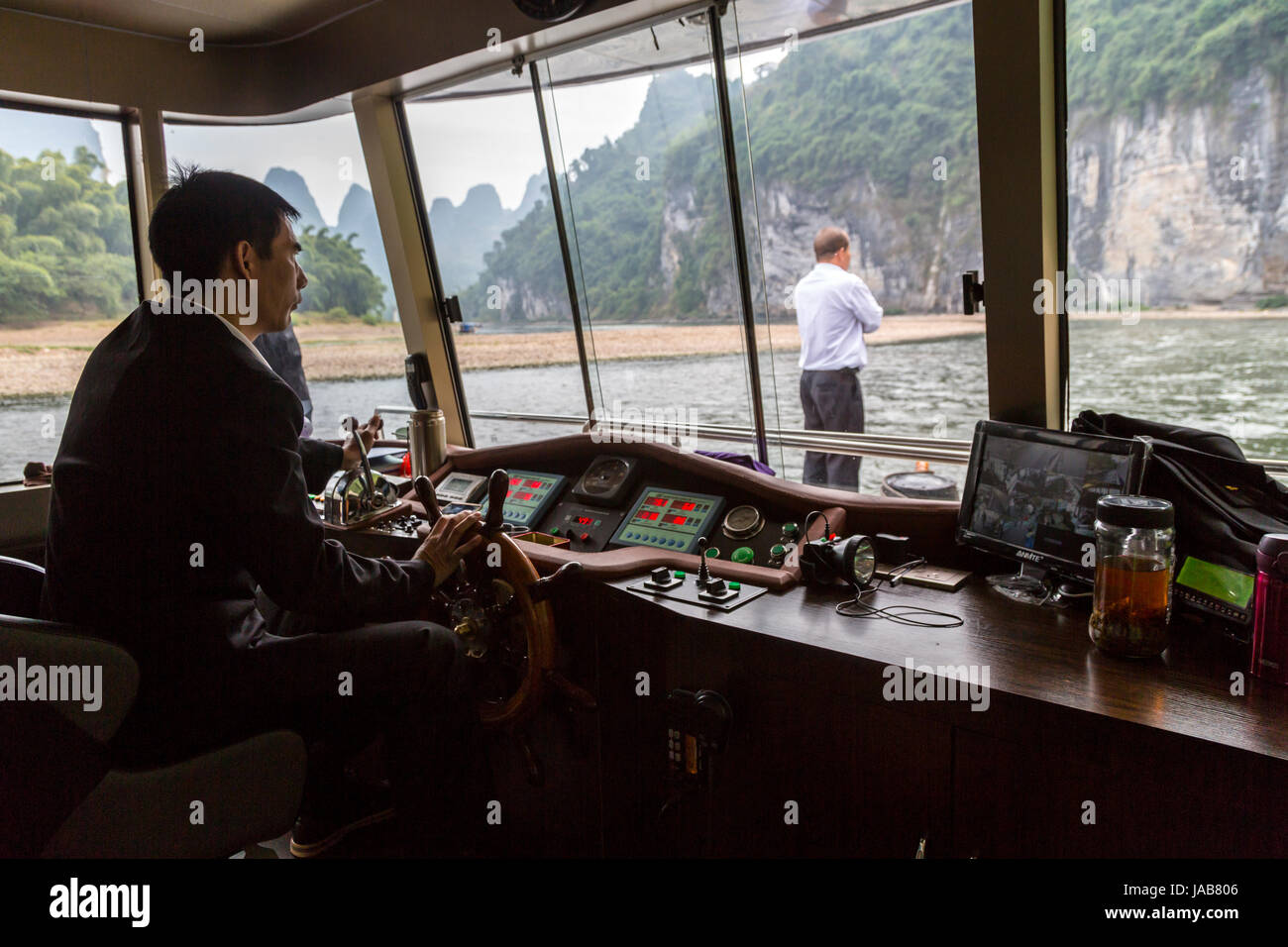 Li River Cruise, Guangxi Region, China. Boat Pilot in his cabin Stock ...