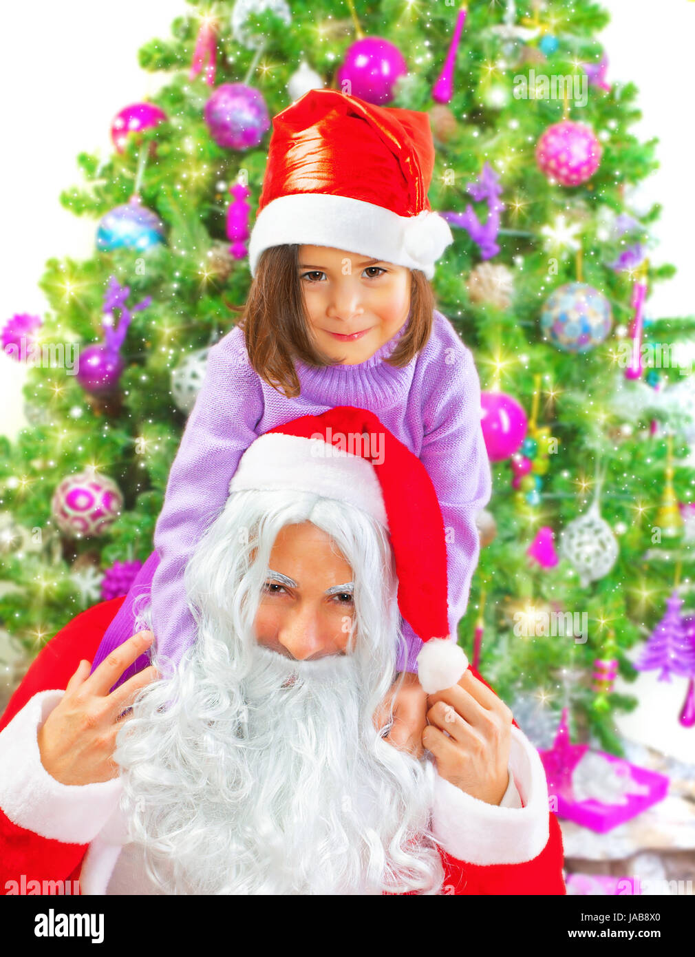 Portrait of Santa Claus holding on back cute little girl, beautiful ...