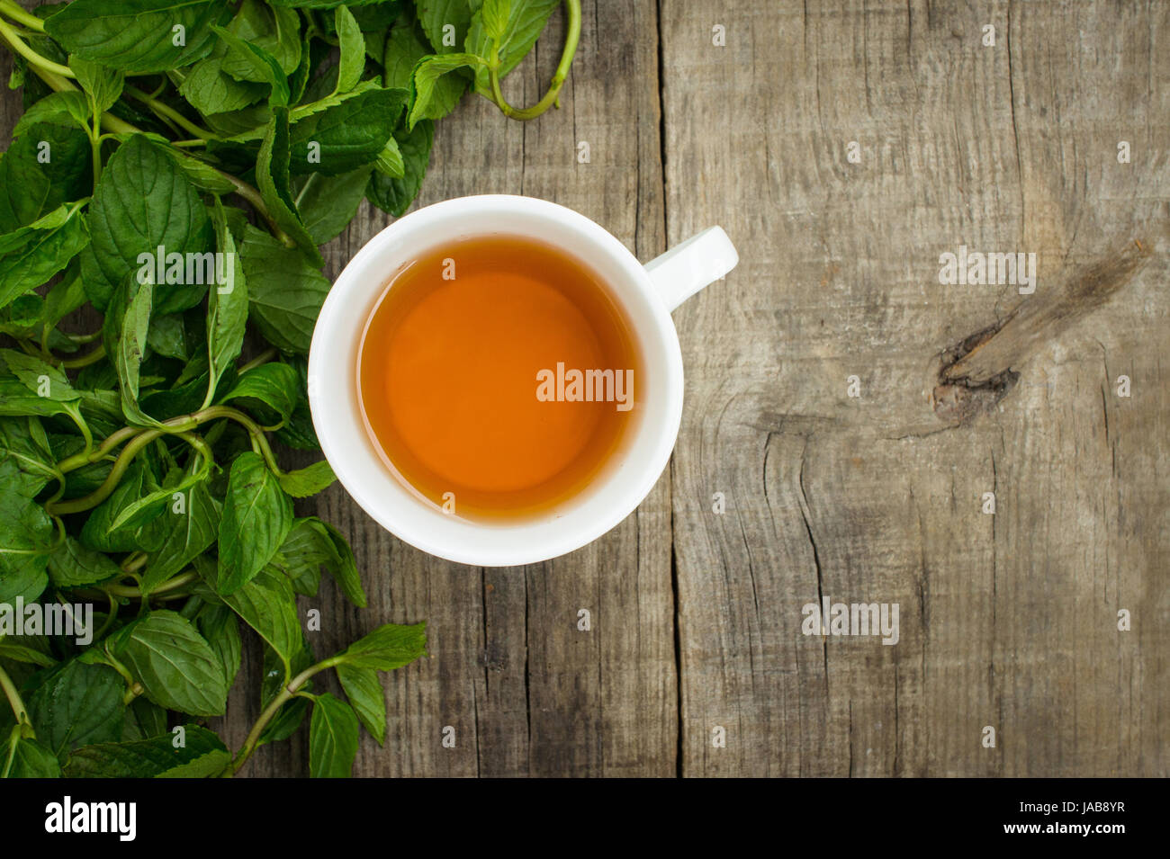 A cup of mint tea on wood textured background Stock Photo - Alamy
