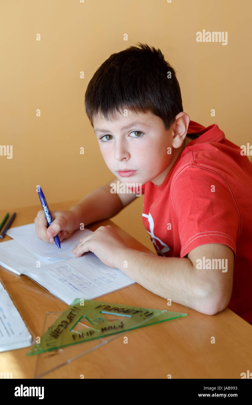 boy doing school homework from mathematics in workbook Stock Photo - Alamy