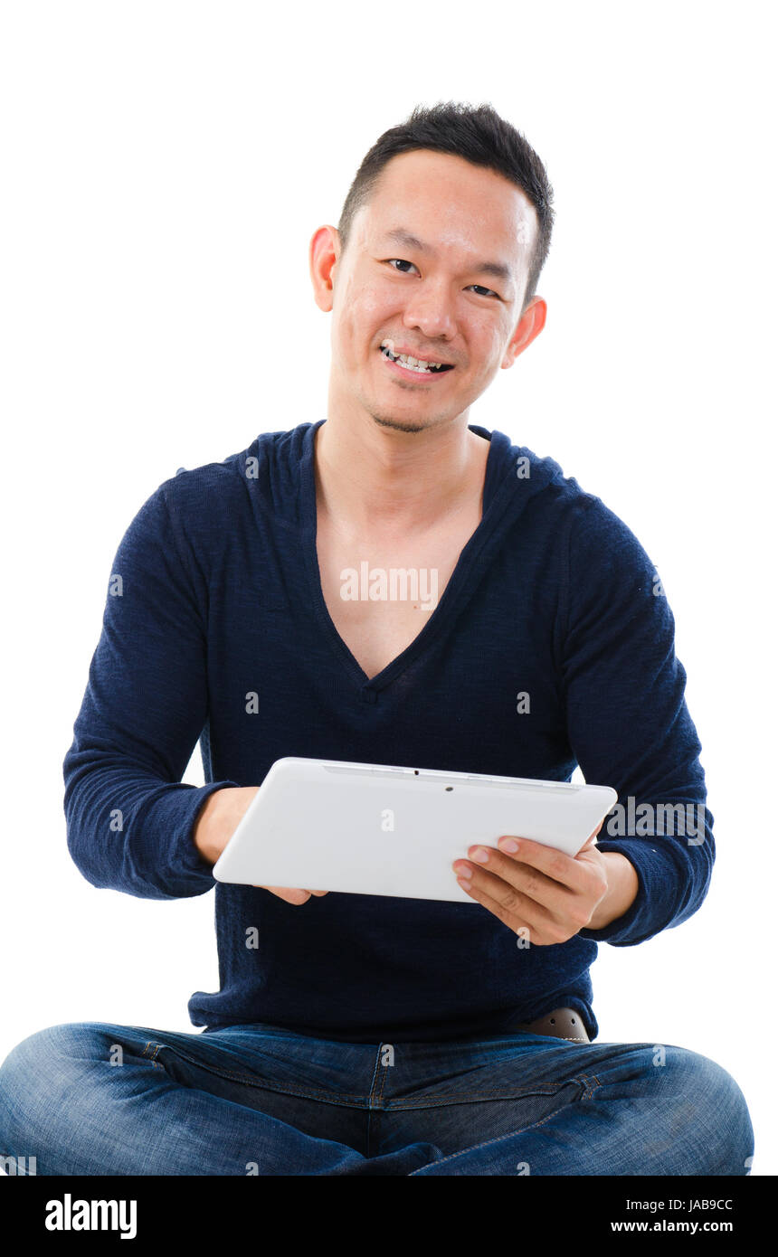 Asian man holding tablet computer isolated on white background Stock ...