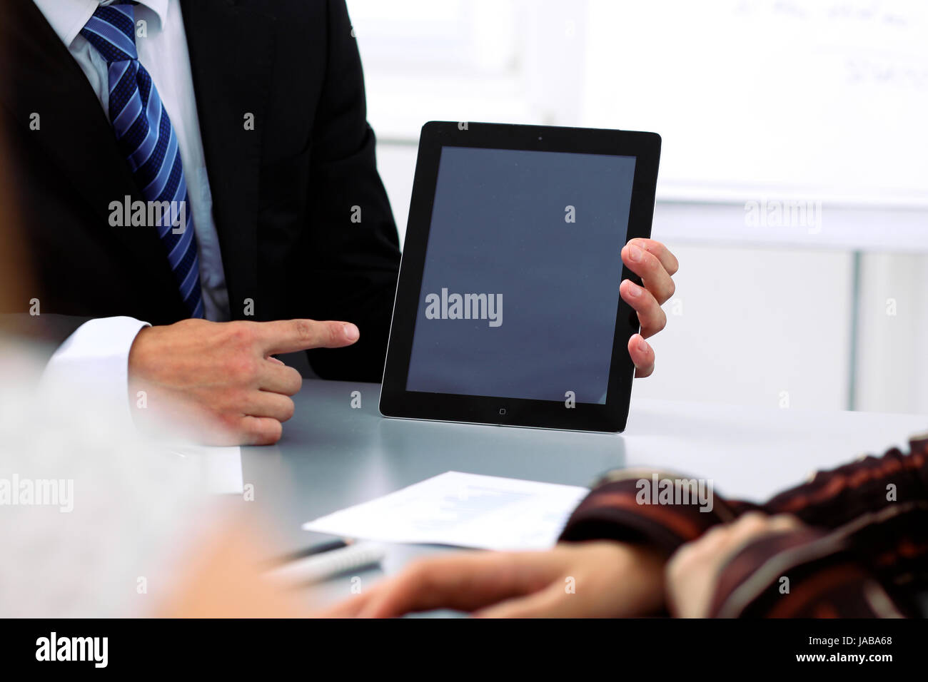 Group of business people at meeting, close up. Boss pointing into ...