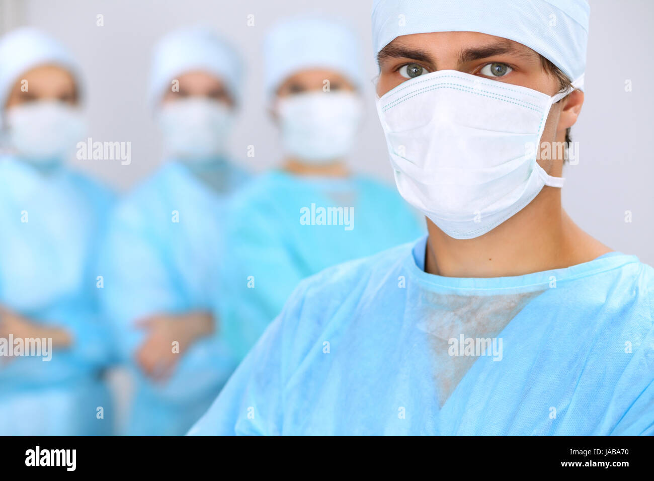Medical team performing operation. Focus on male surgeon Stock Photo ...