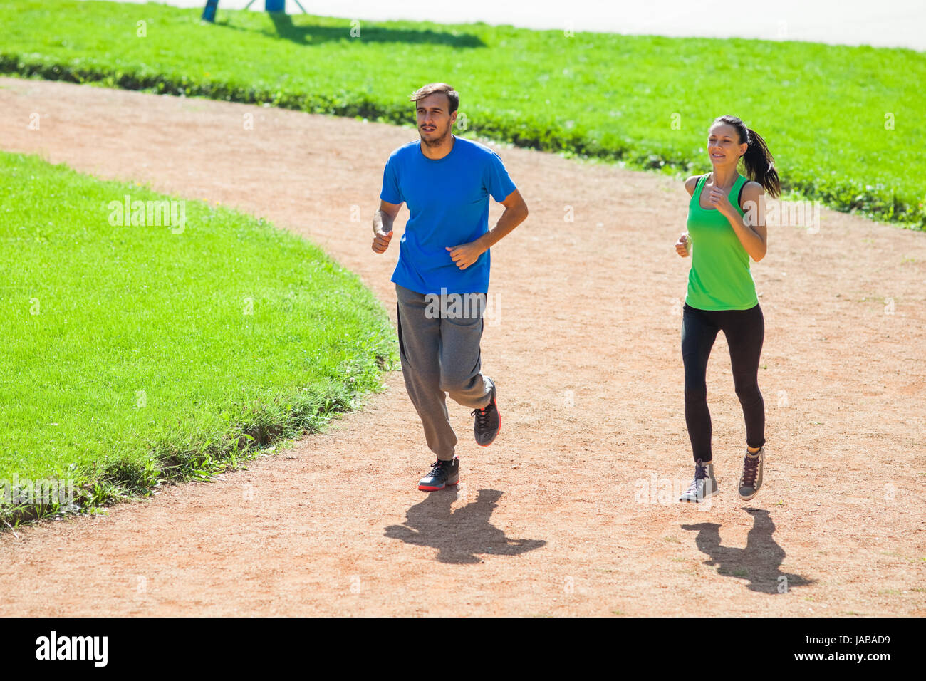Happy couple jogging outdoor Stock Photo - Alamy