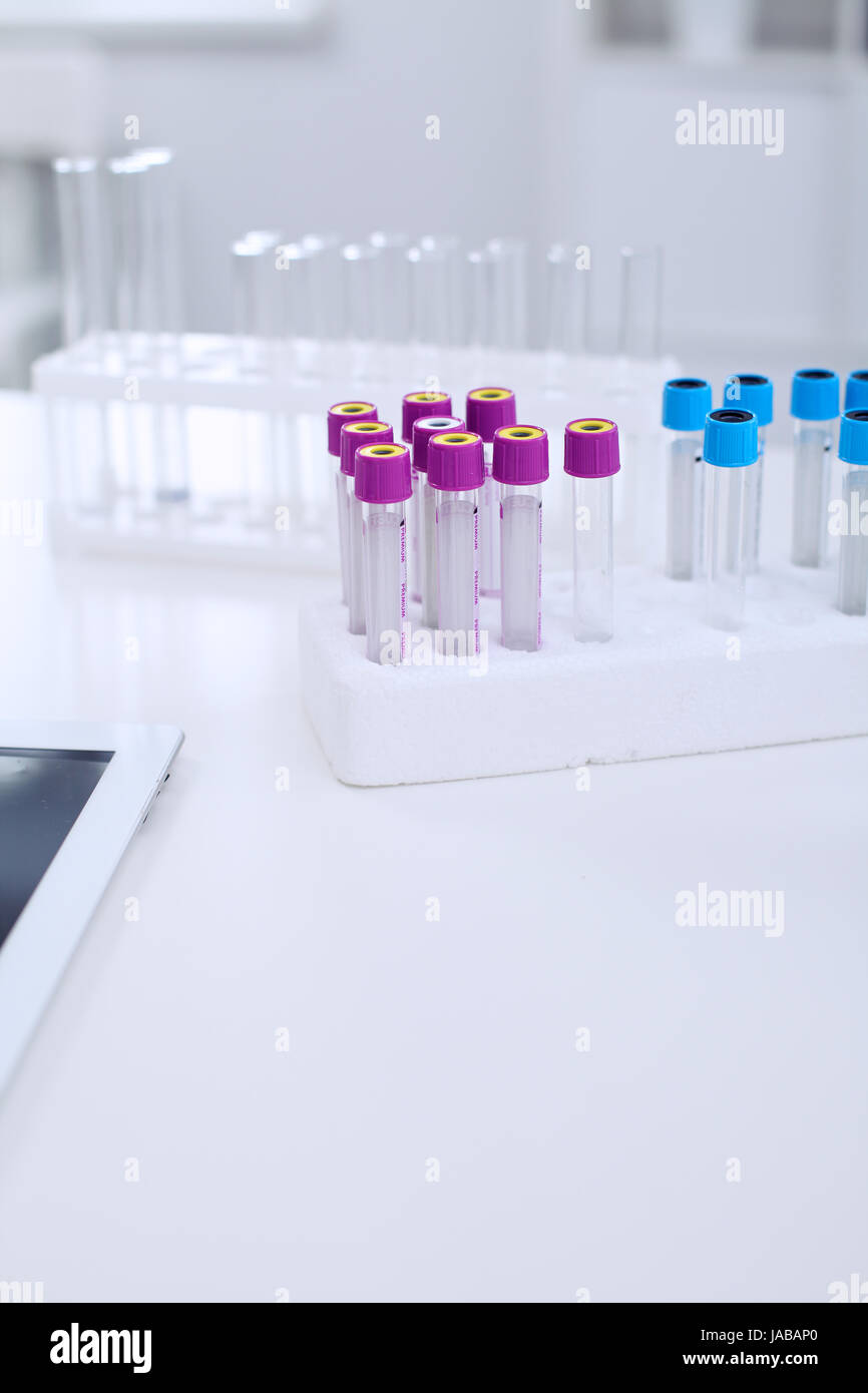 Research laboratory working space. Test tubes and tablet PC are lying ...