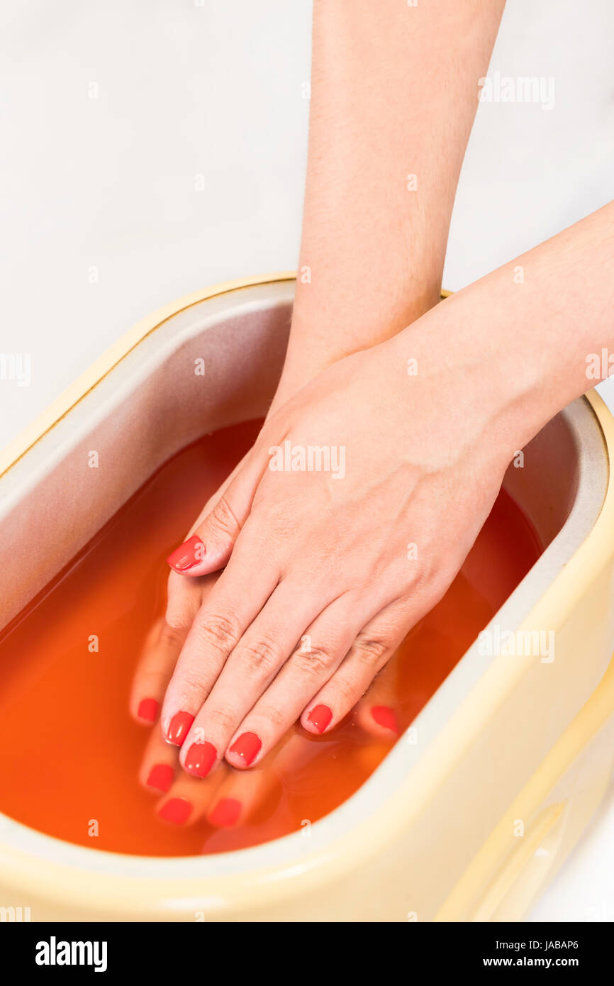 Process paraffin treatment of female hands in beauty salon Stock Photo ...