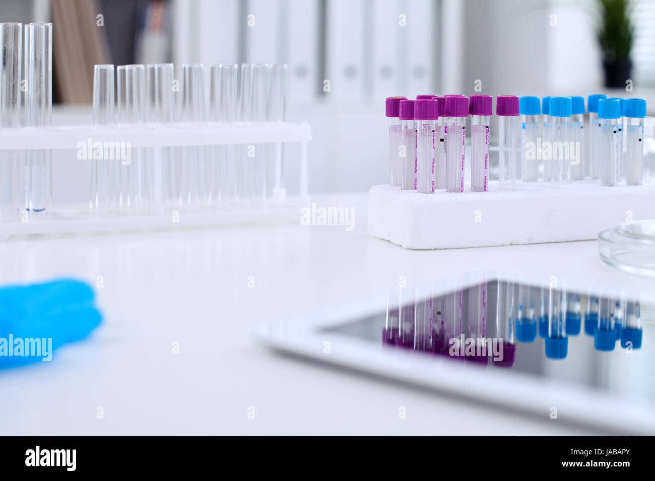 Research laboratory working space. Test tubes and tablet PC are lying ...