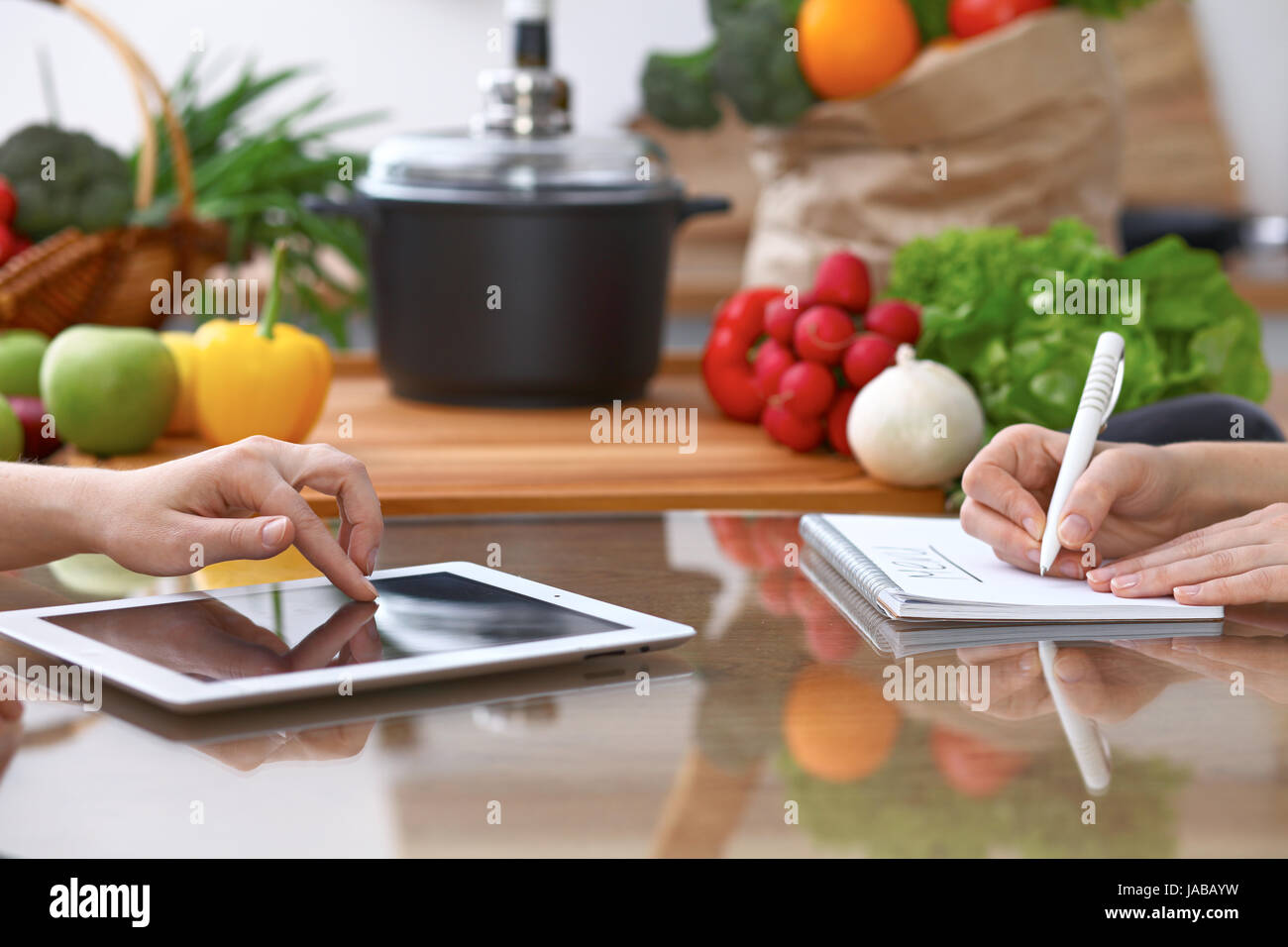 Woman making salad using tablet hi-res stock photography and images - Alamy