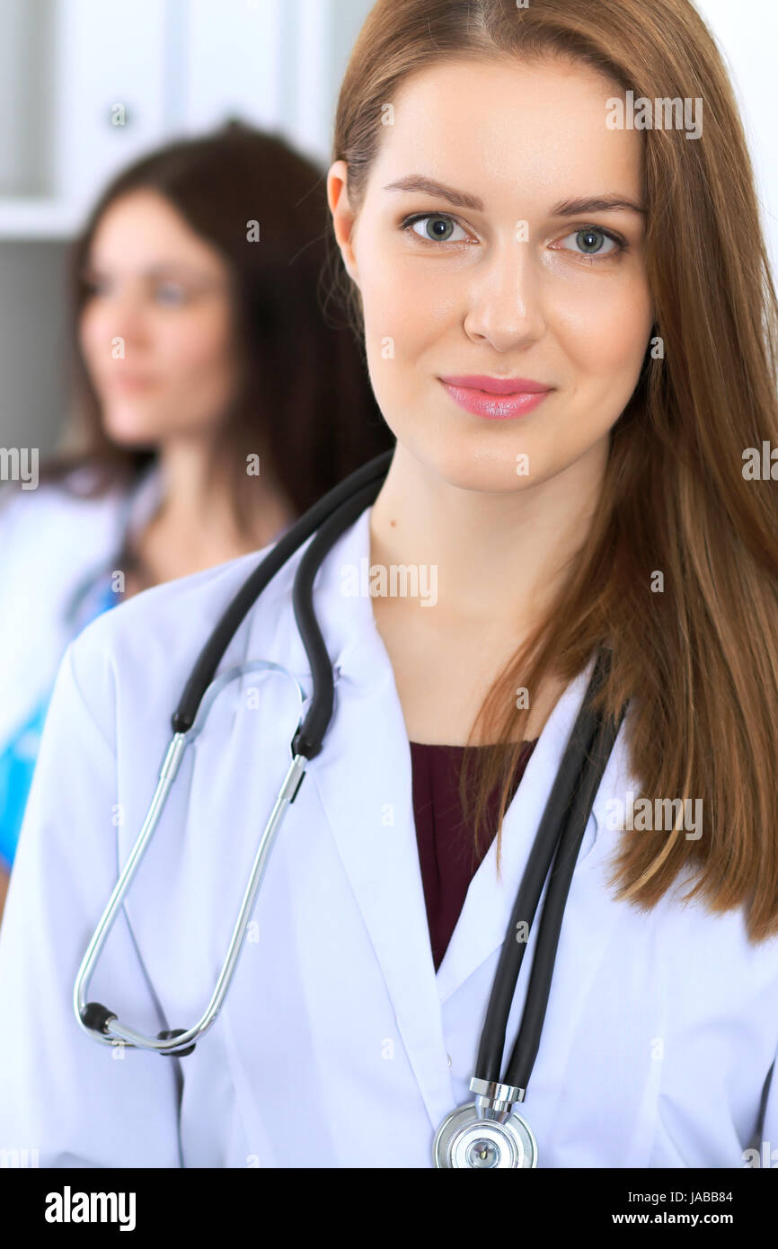 Young beautiful female doctor smiling to patient while consulting her ... Young beautiful female doctor smiling to patient while consulting her ...
