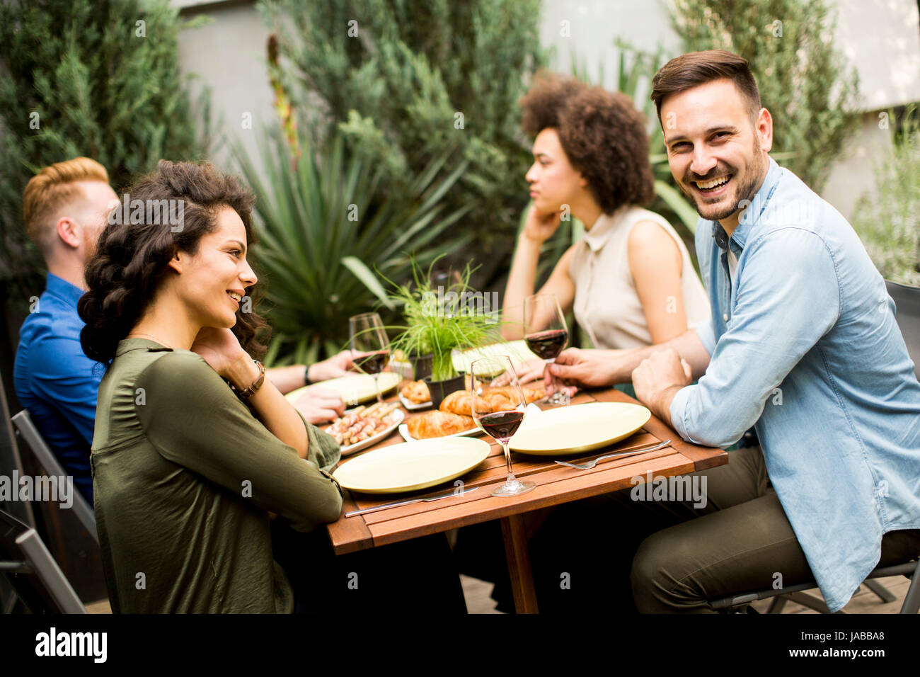 Cheerful young people have lunch in the courtyard and have a fun Stock ...