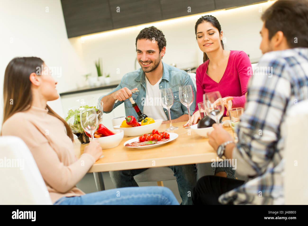View at young people have a meal in the dining room in modern home ...