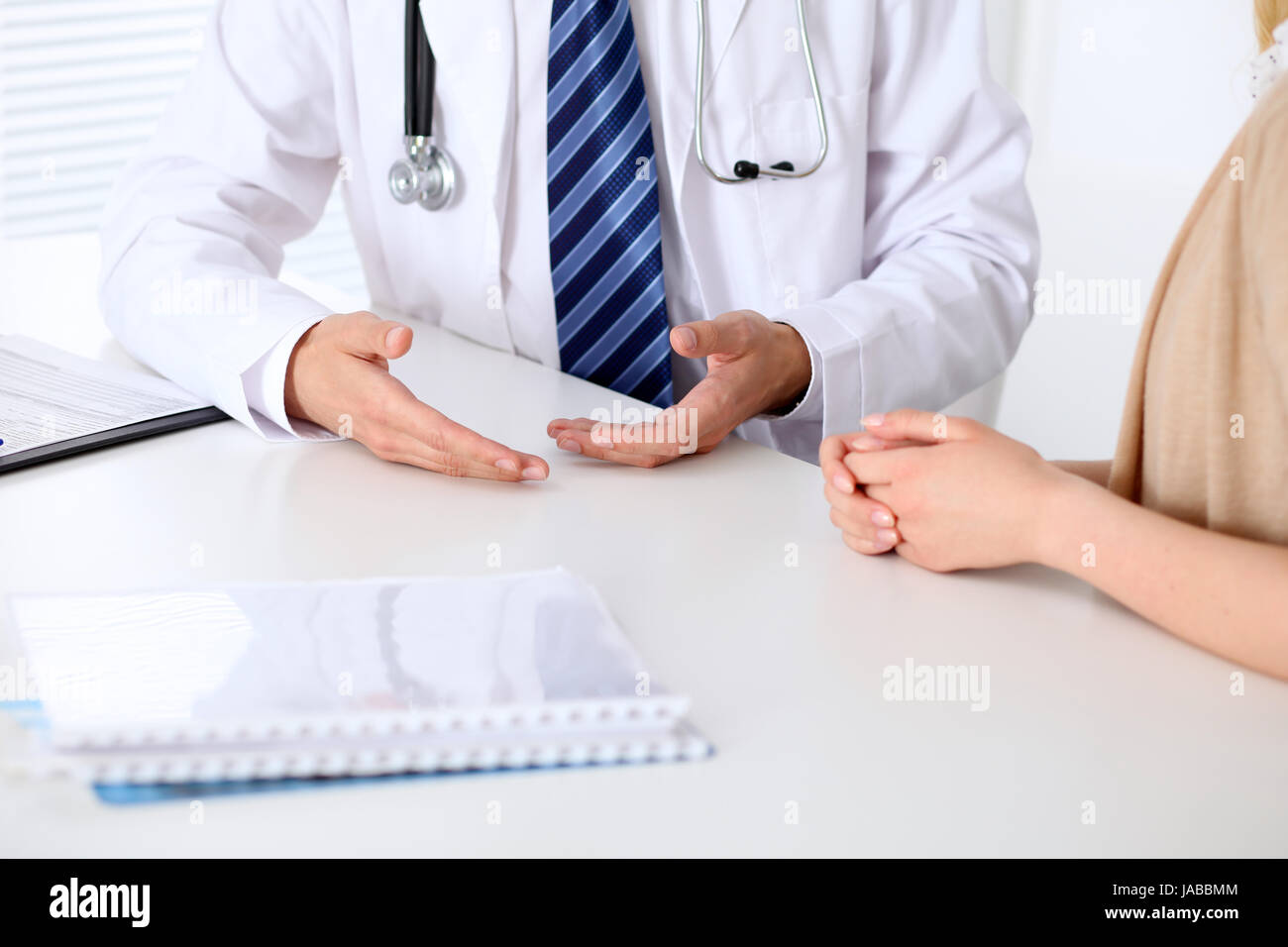 Hand of doctor reassuring her female patient. Medical ethics and trust ...
