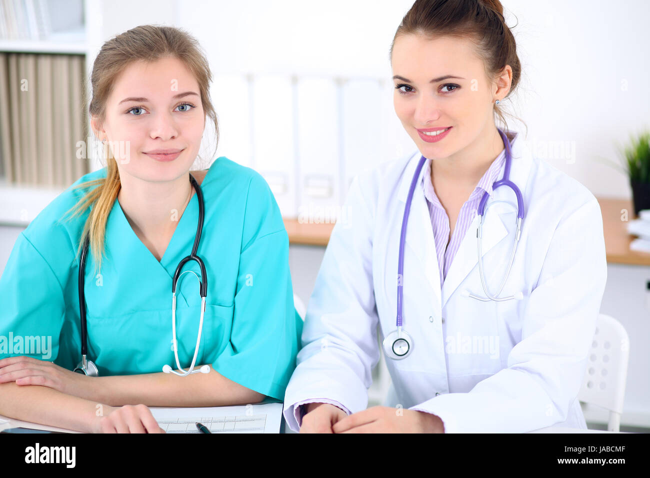 Female doctor and young surgeon intern in hospital Stock Photo - Alamy
