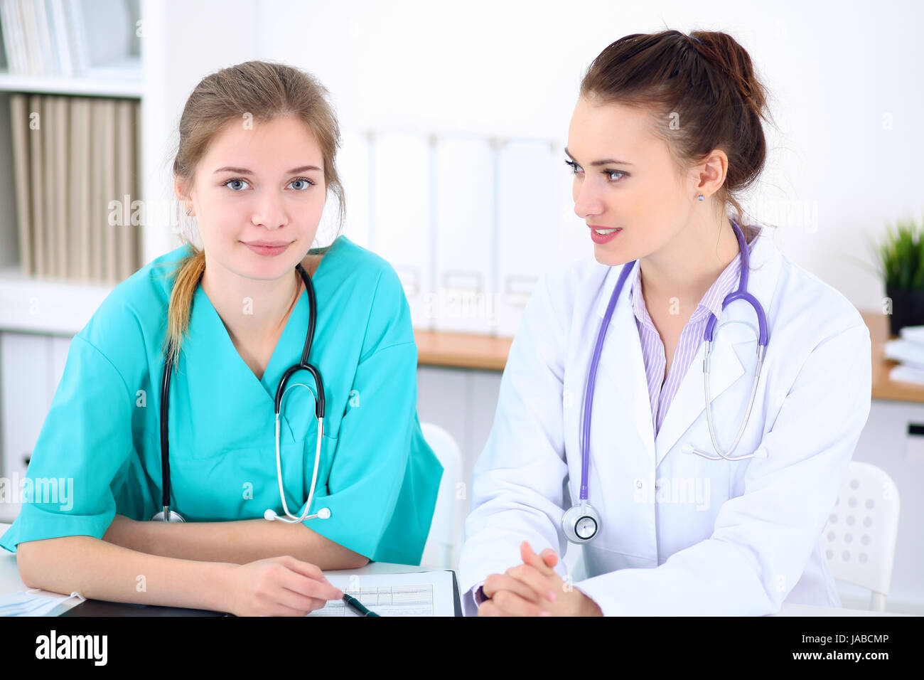 Female doctor and young surgeon intern in hospital Stock Photo - Alamy