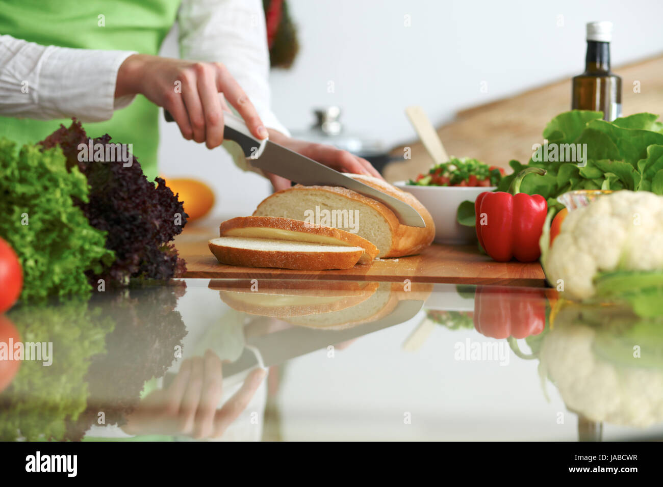 Closeup of human hands cooking in kitchen on the glass table with ...