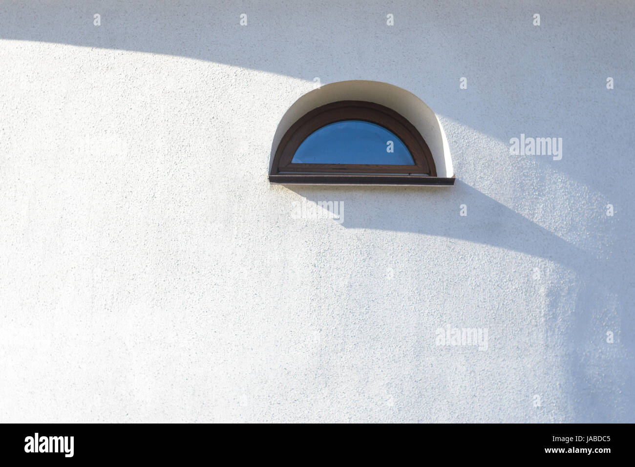 Latticed window in arches shape at white medieval church wall Stock ...