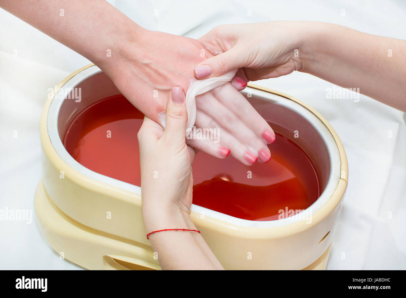 Process paraffin treatment of female hands in beauty salon Stock Photo ...