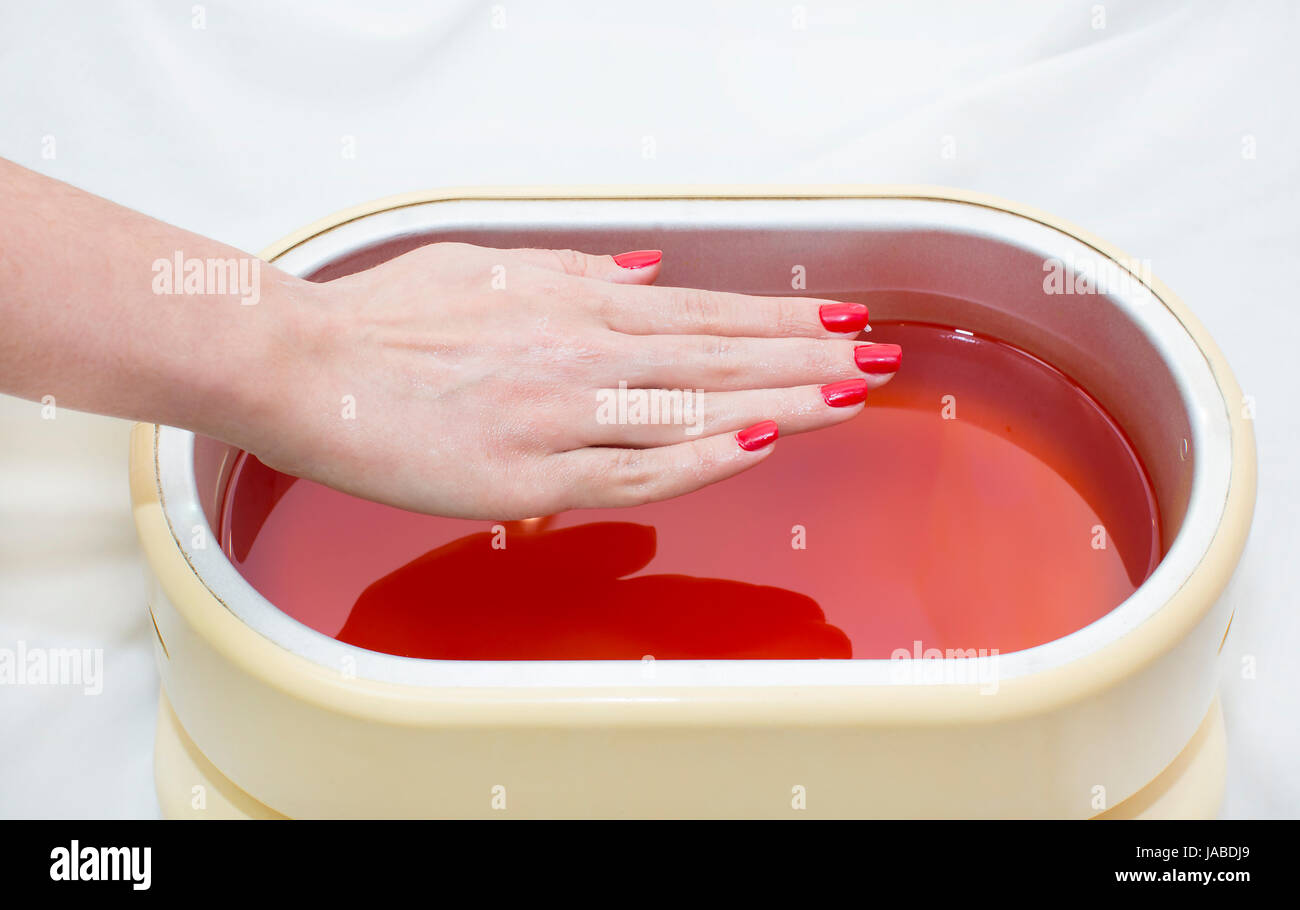 Process paraffin treatment of female hands in beauty salon Stock Photo ...