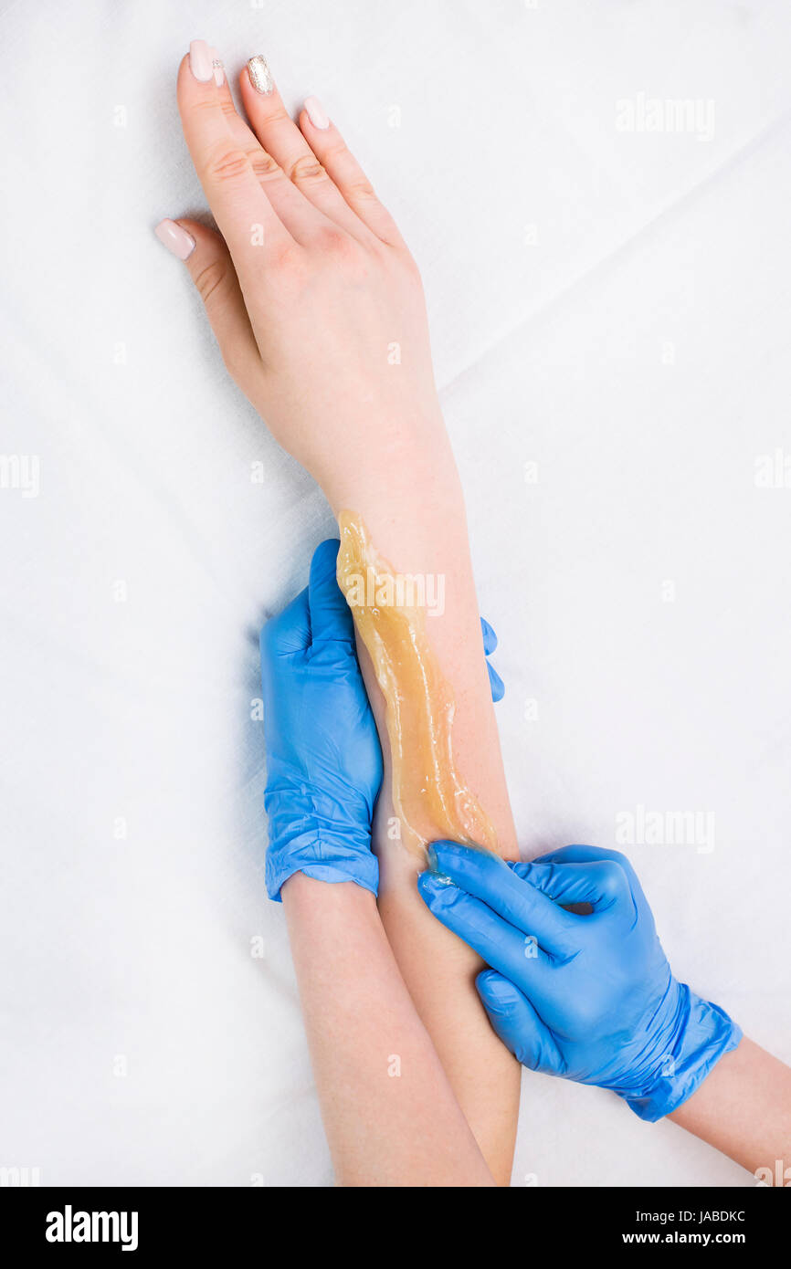 Epilation sugar processes woman passes in a beauty salon Stock Photo ...