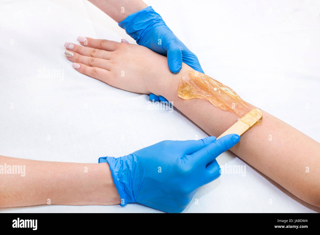 Epilation sugar processes woman passes in a beauty salon Stock Photo ...