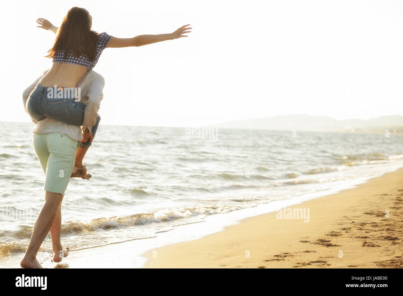 Guy carrying girl on back hi-res stock photography and images - Alamy