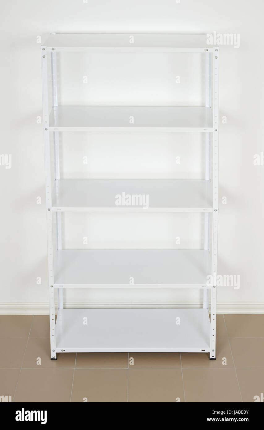 white metal rack near the wall, empty shelves Stock Photo - Alamy