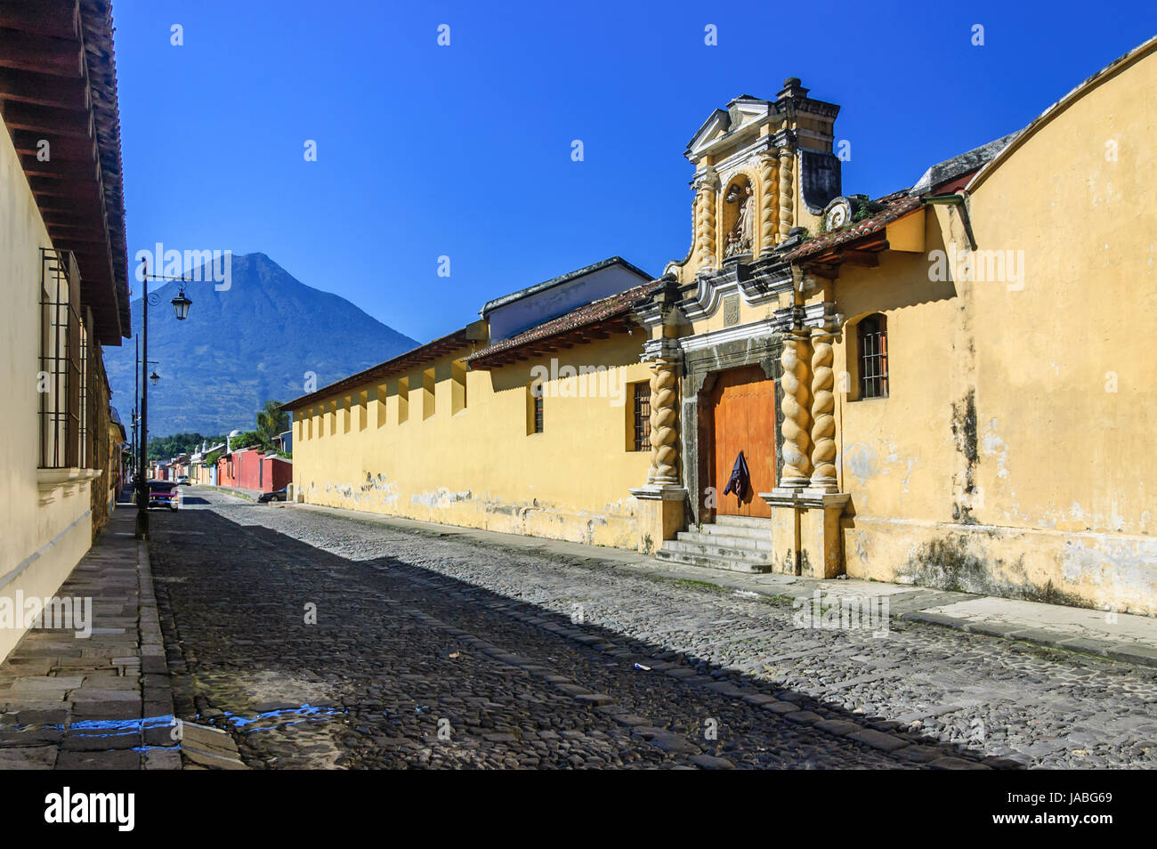 Agua volcano & cobblestone street in colonial city & UNESCO World ...