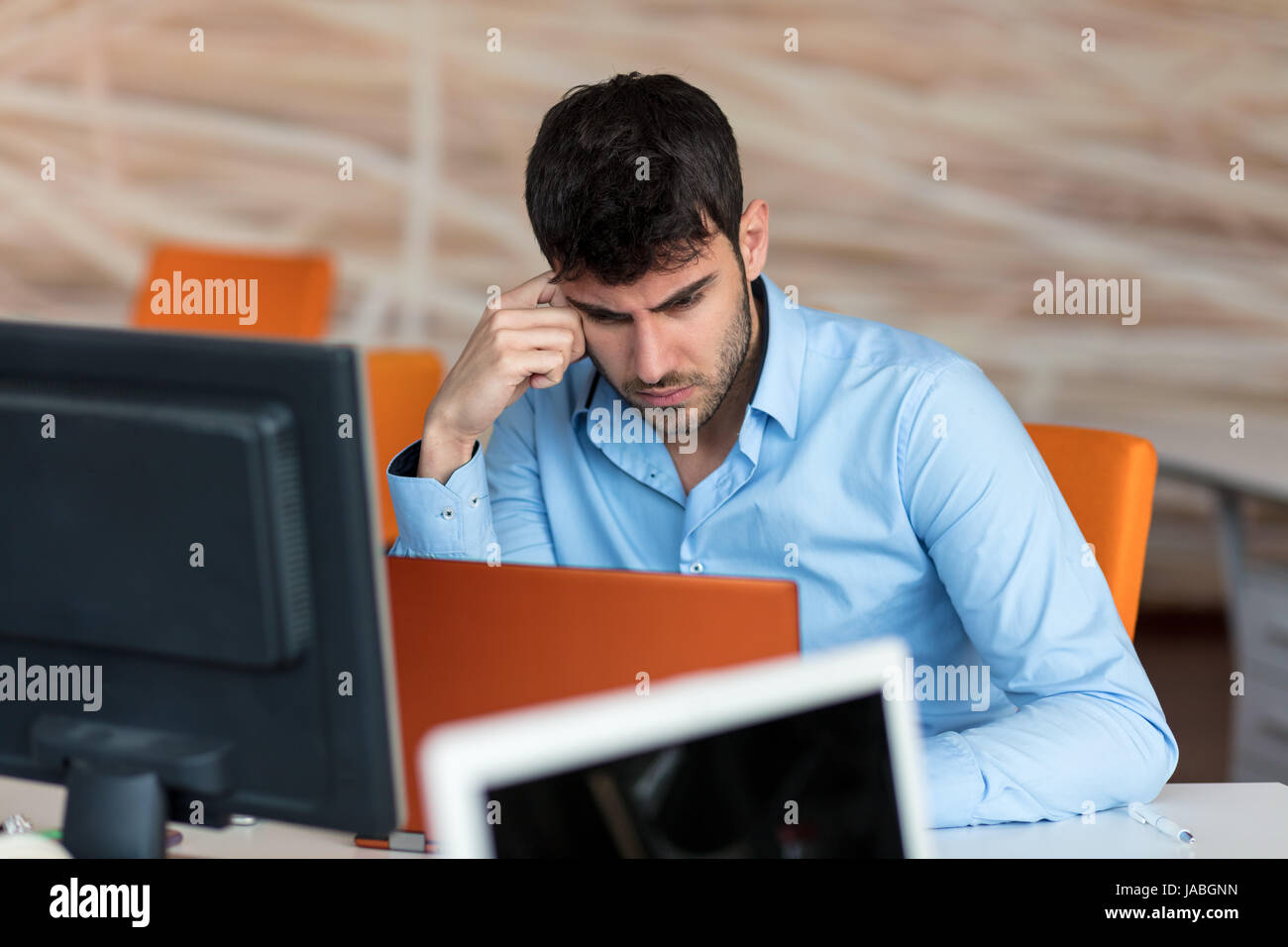 Worried businessman working at his desk in his office Stock Photo - Alamy