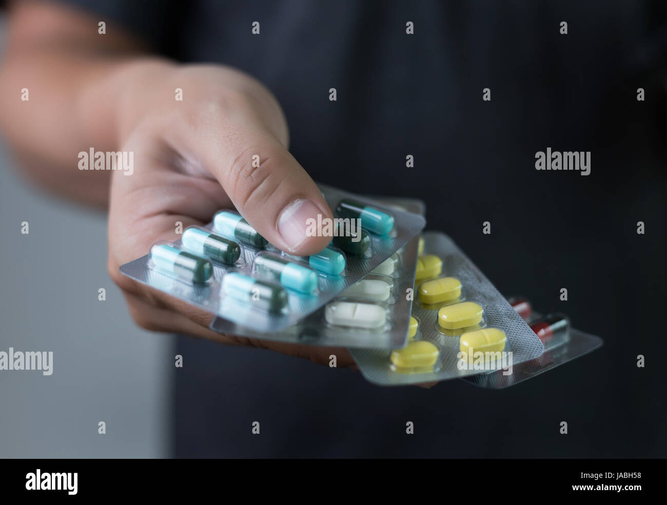 man Hand holding medicine pack at the pharmacy Variety of medicines and ...