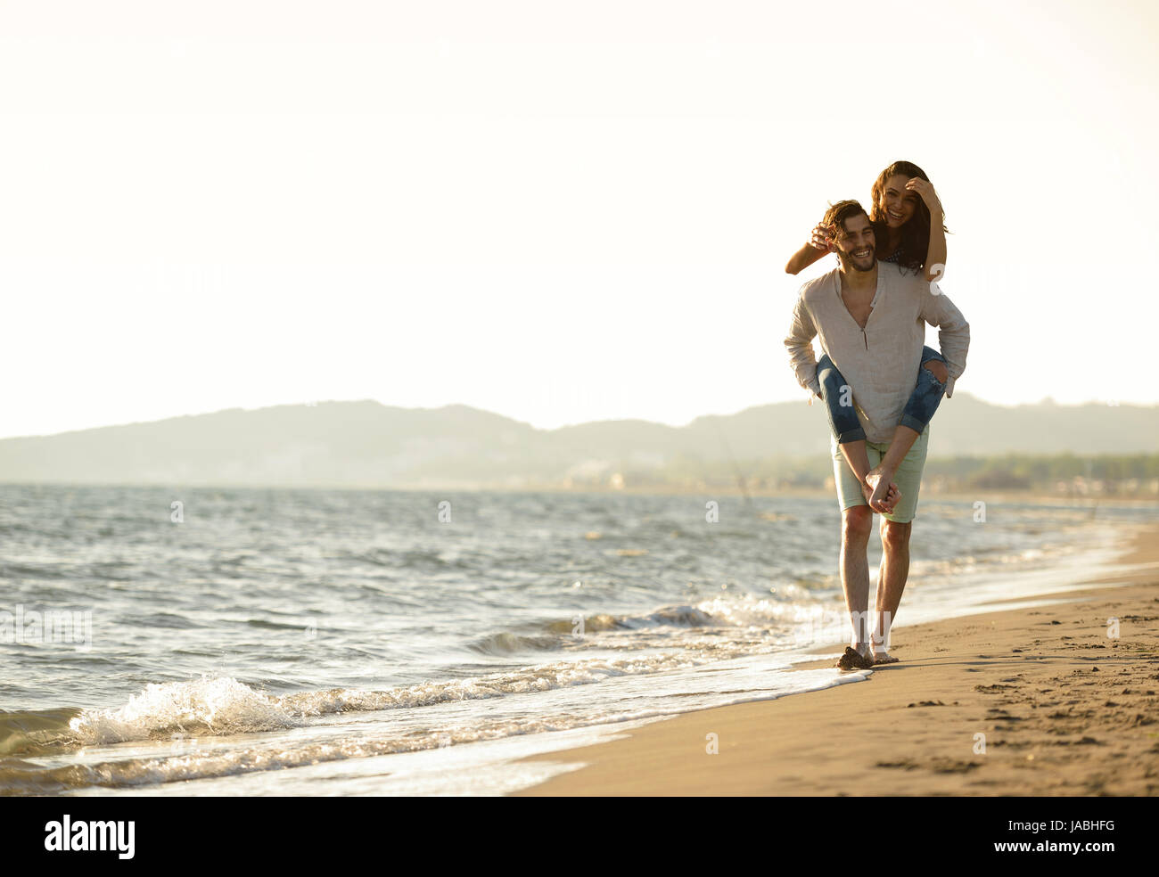 Guy Carrying Girl On Shoulders At Beach Stock Photo