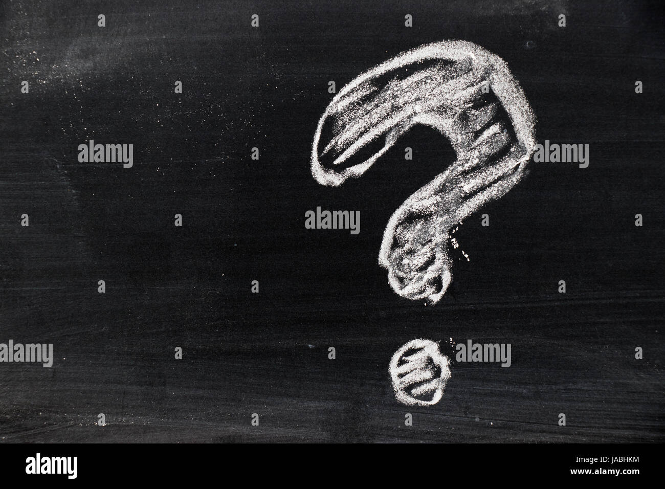Chalk hand drawing as question mark shape on black board background ...