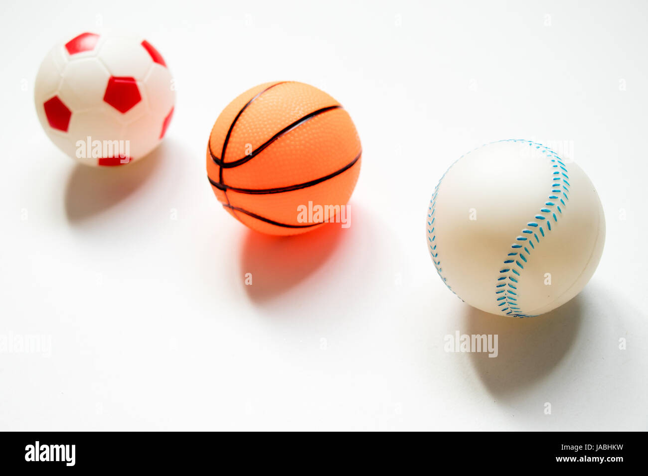 Group of football, baseball and basketball placed on white background ...