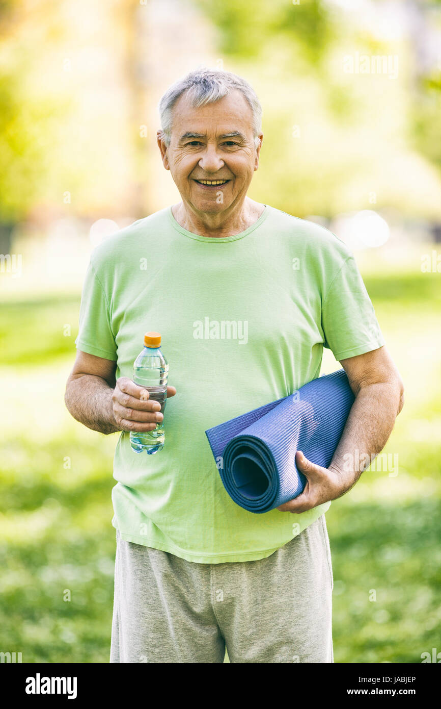 Senior man is ready for exercise in park. Active retirement Stock Photo ...