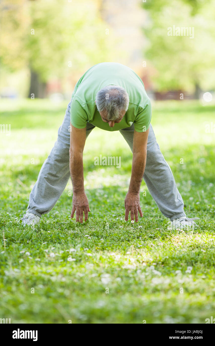 Senior man is exercising in park. Active retirement Stock Photo - Alamy