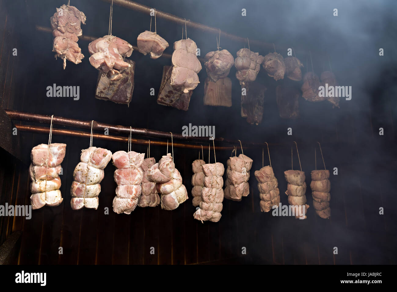 smoking meat in the traditional smokehouse Stock Photo - Alamy