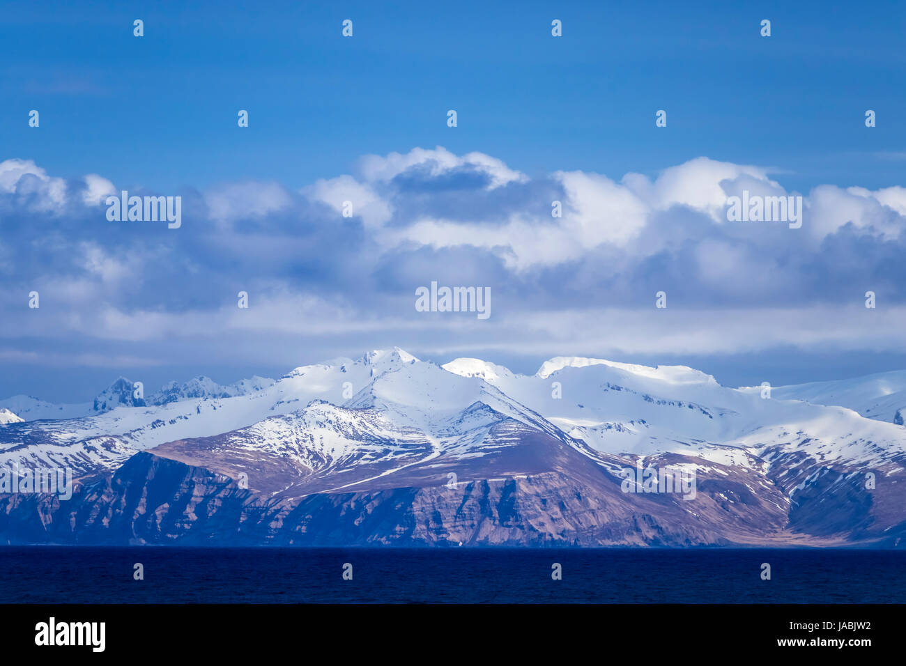 A chain of snow capped mountains in the Aleutian Islands near Unimak ...
