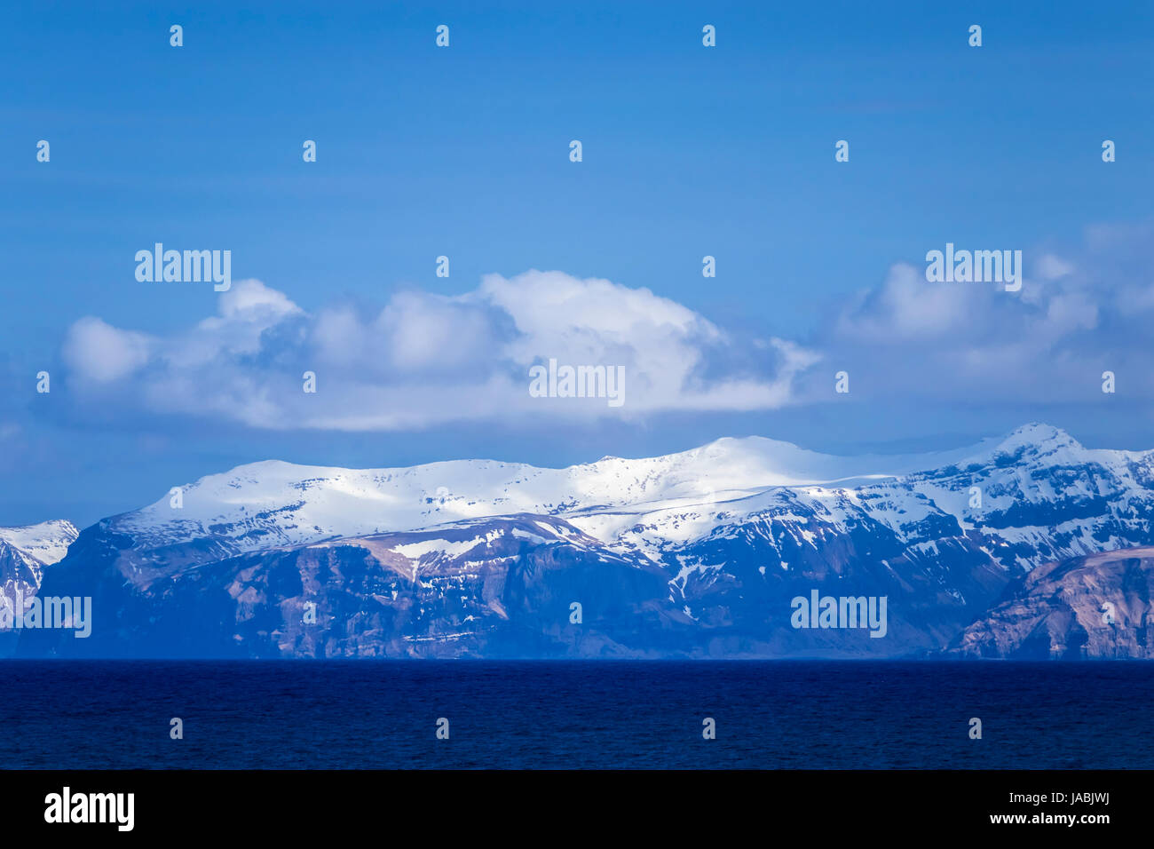 A chain of snow capped mountains in the Aleutian Islands near Unimak ...