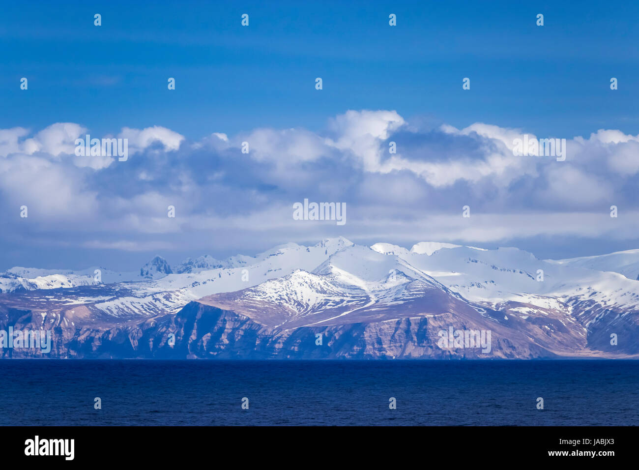 A chain of snow capped mountains in the Aleutian Islands near Unimak ...