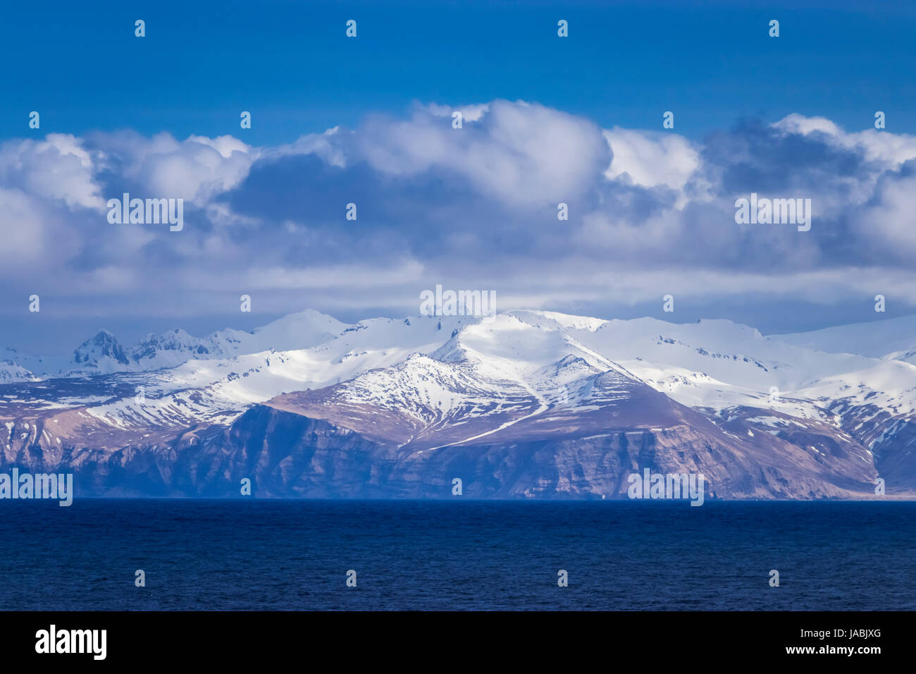 A chain of snow capped mountains in the Aleutian Islands near Unimak ...