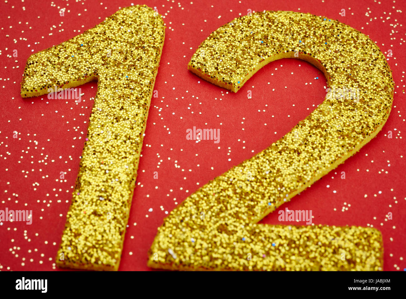Number twelve yellow color over a red background. Anniversary ...